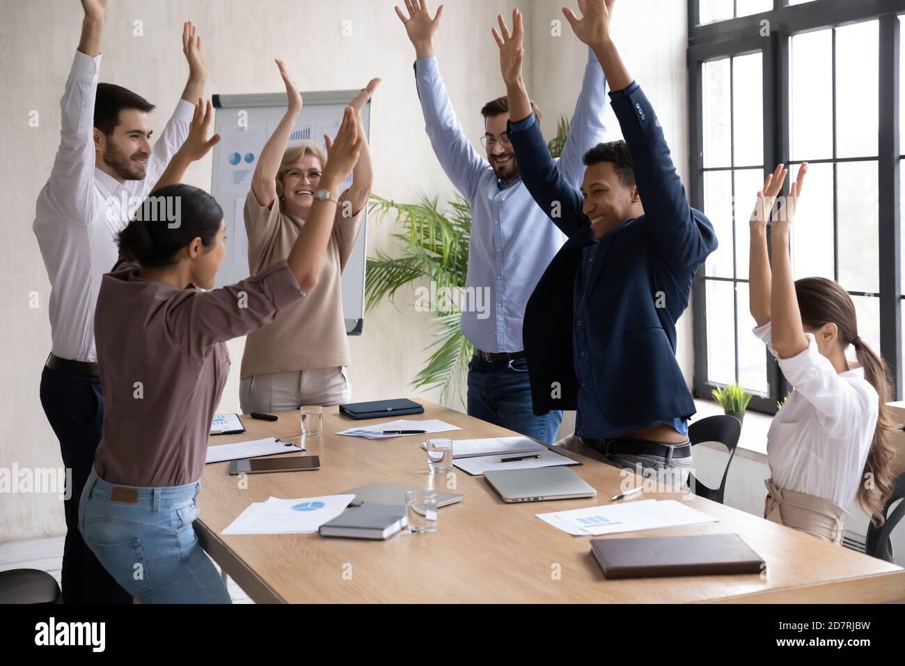 Excited diverse employees participate in teambuilding activity at ...