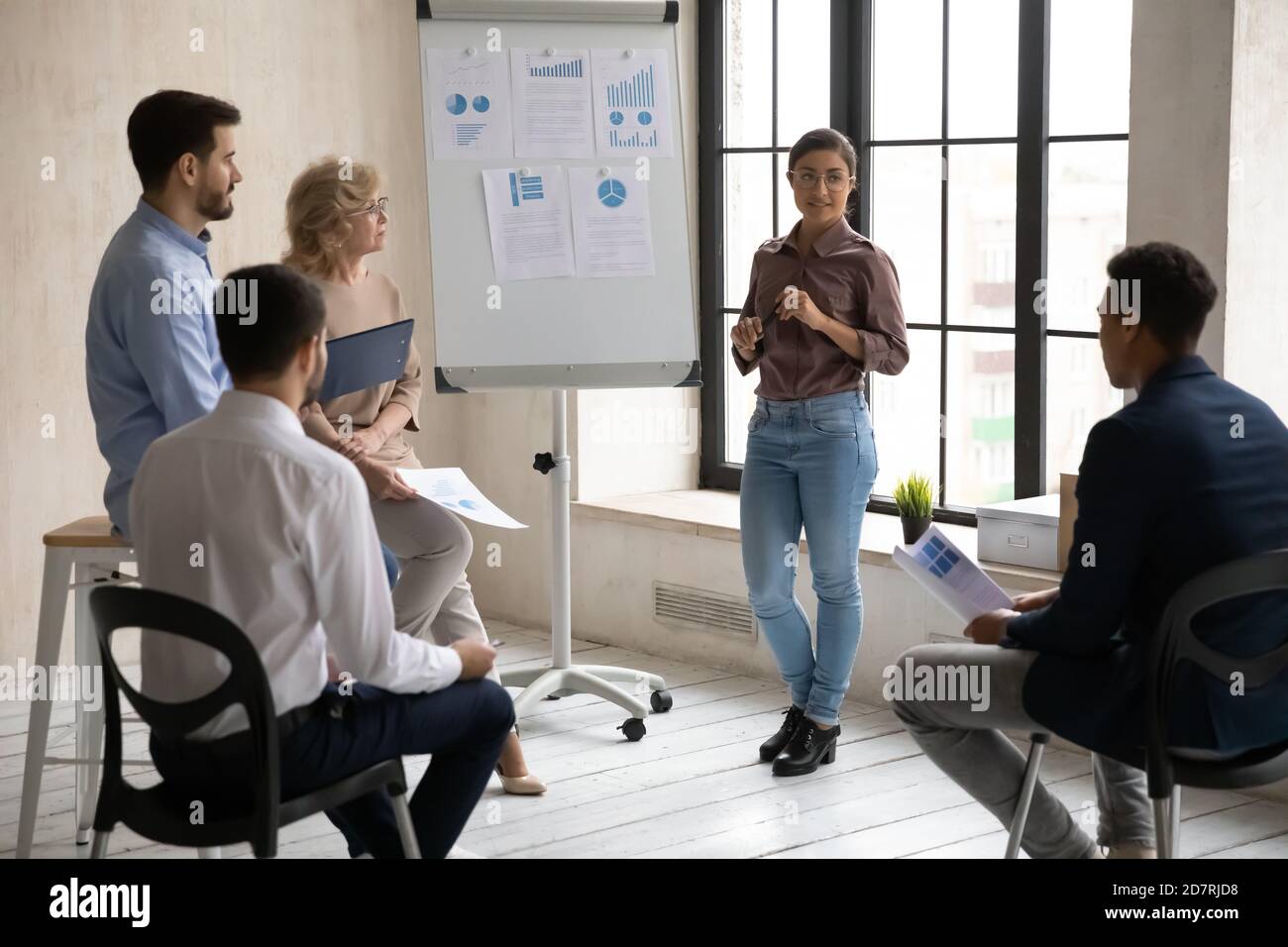 Indian female coach make flip chart presentation for employees Stock ...