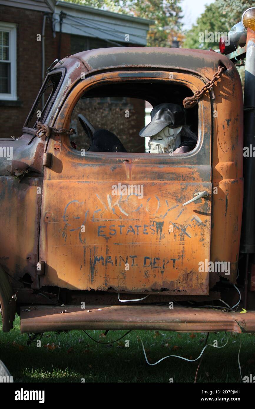 Halloween decoration of a creepy mechanic skeleton driving a rusted old ...