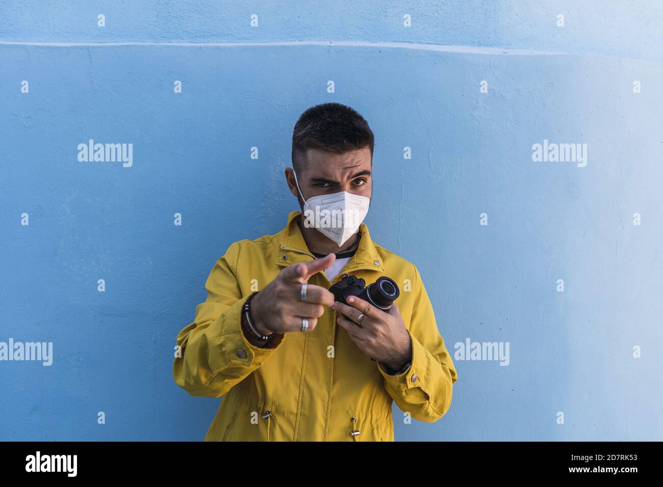 Closeup shot of a young man posing wearing a sanitary mask-concept of ...