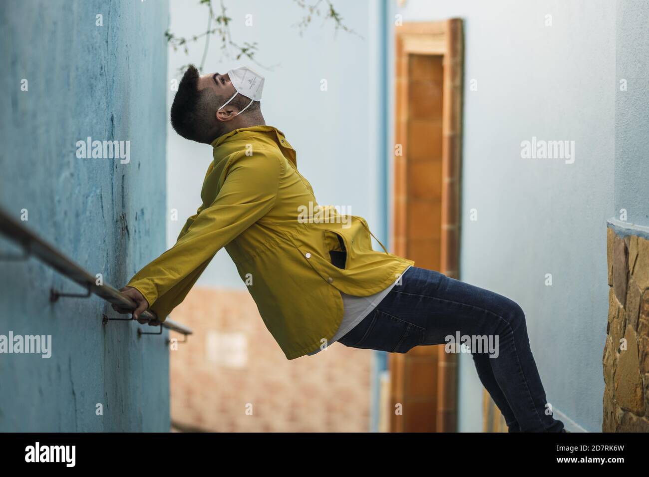 Closeup shot of a young man posing wearing a sanitary mask-concept of ...