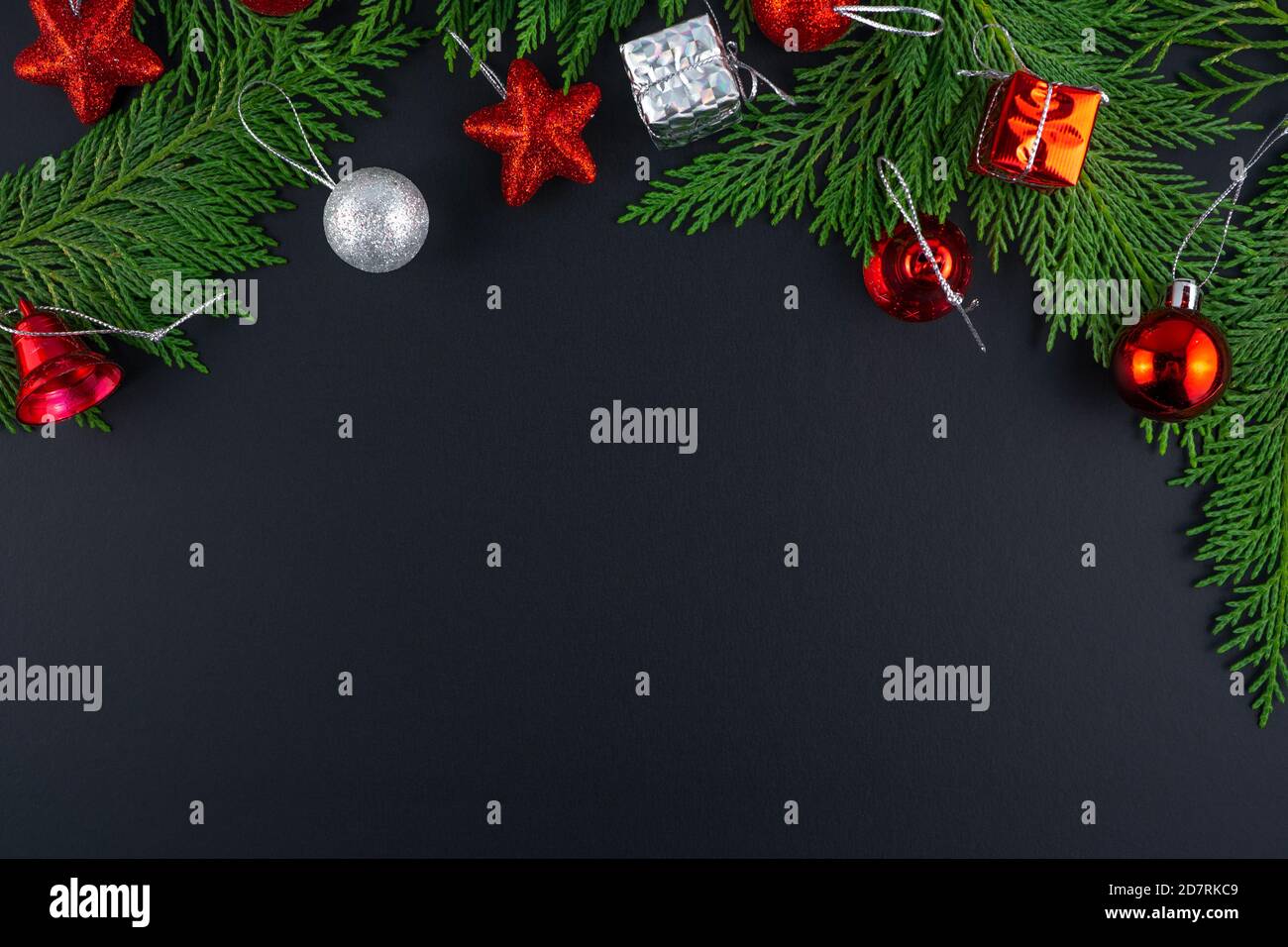 Christmas composition. Fir tree, silver and red decorations on black ...