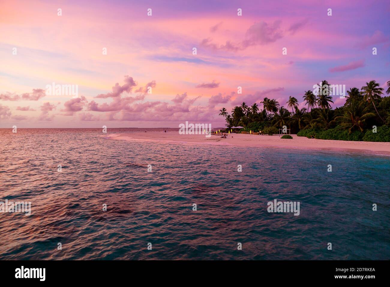 Breathtaking view of the wavy ocean gleaming under the cloudy purple ...
