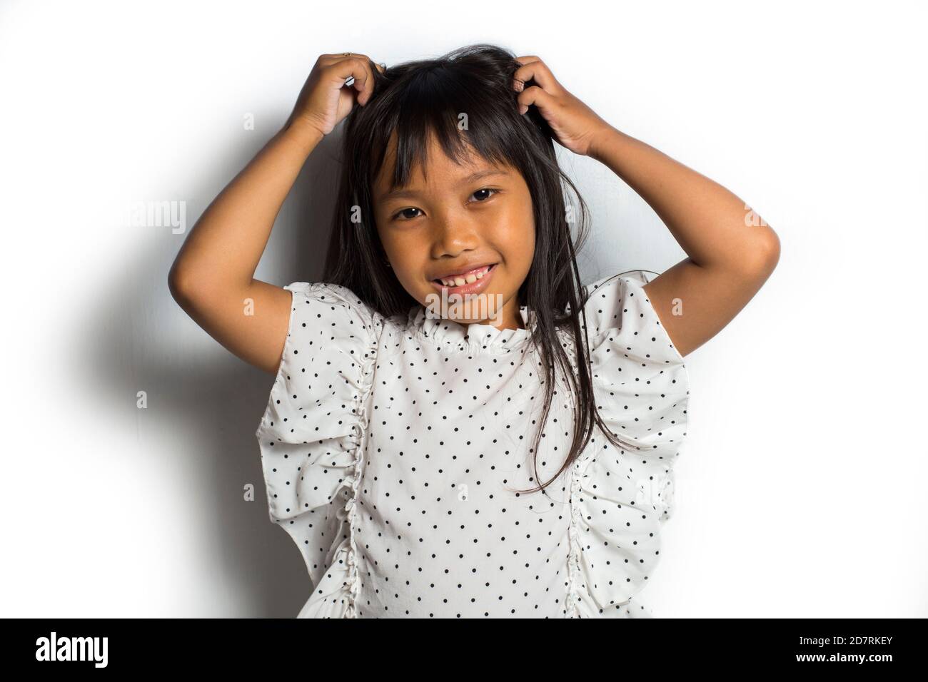 Asian little girl itching scratching her head Stock Photo - Alamy