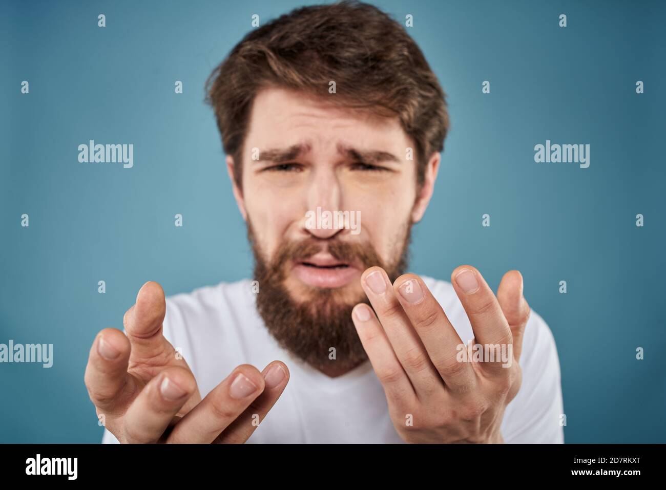 Bearded man displeased facial expression emotions close-up blue ...