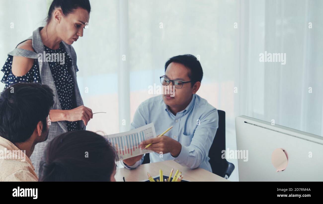 Unhappy business people in group meeting in office. The team is ...