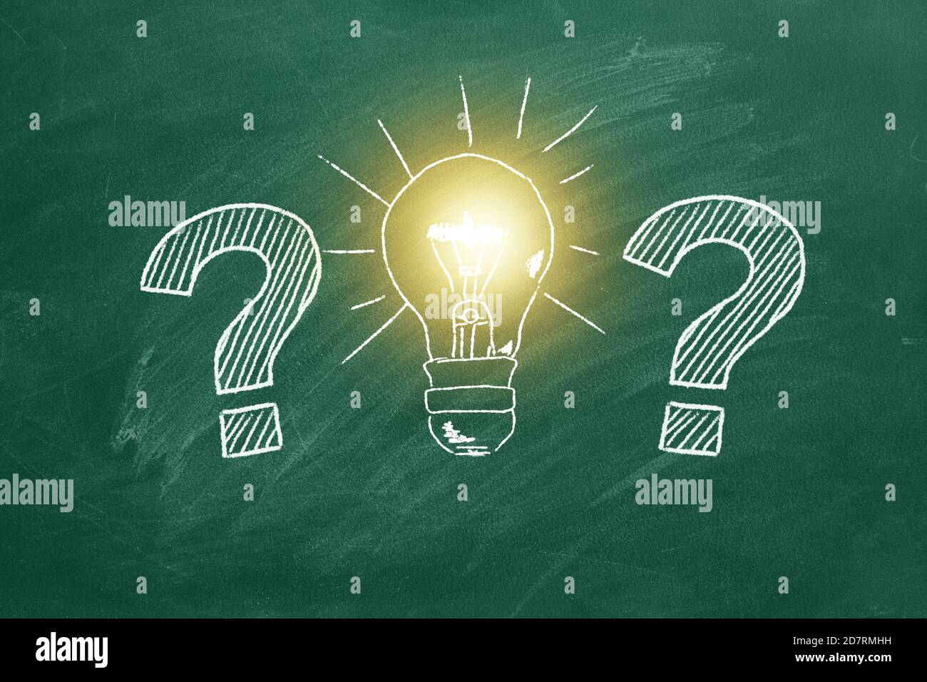 Two question marks turns into a light bulbs. Chalk drawing on a ...