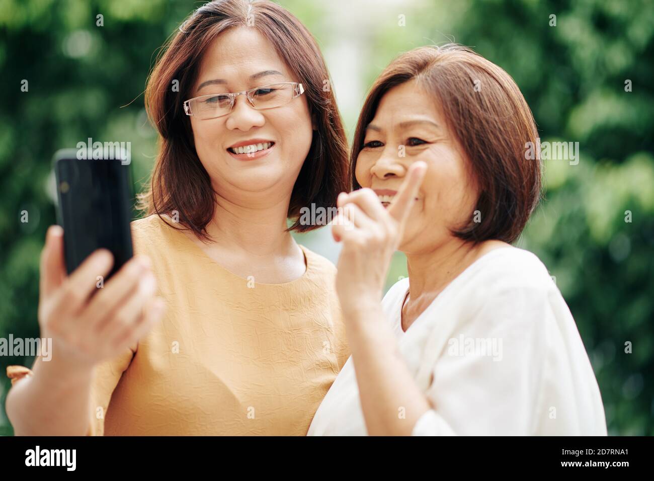Senior women video calling friend Stock Photo - Alamy