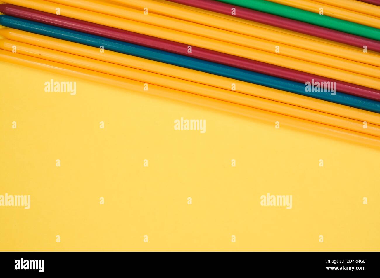 High angle shot of colorful crayons on a yellow surface Stock Photo - Alamy
