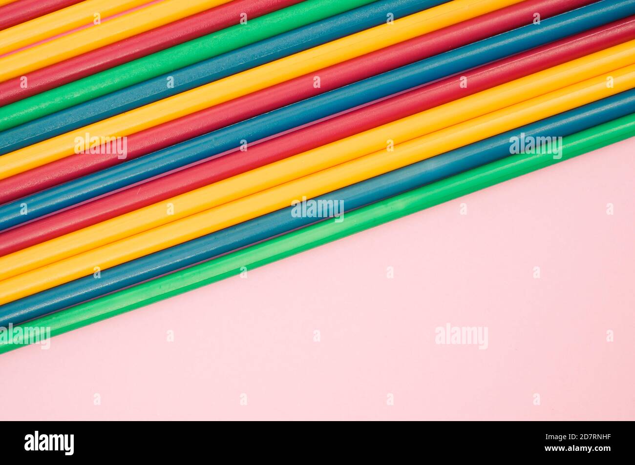 High angle shot of colorful crayons on a pink surface Stock Photo - Alamy
