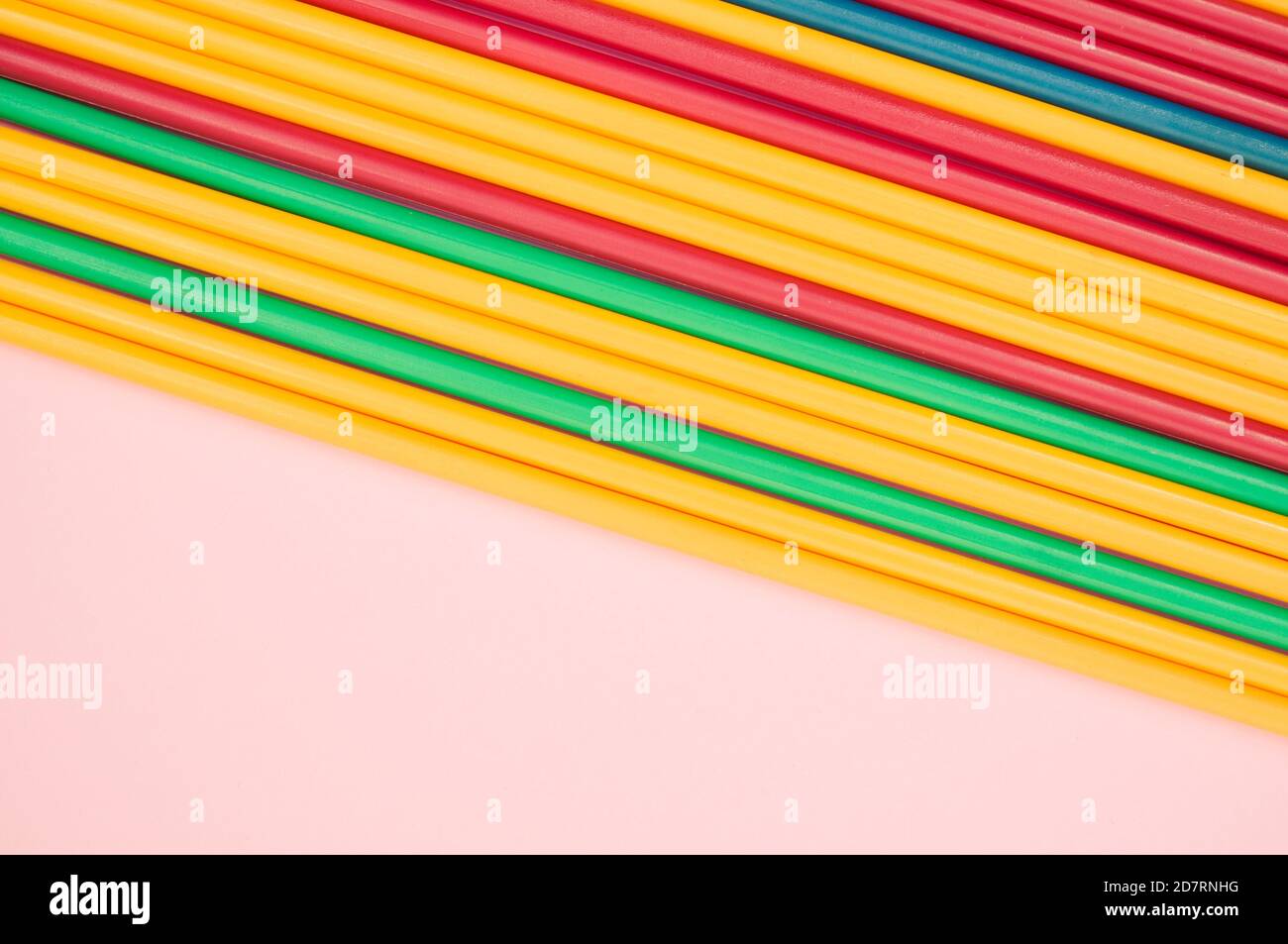 High angle shot of colorful crayons on a pink surface Stock Photo - Alamy