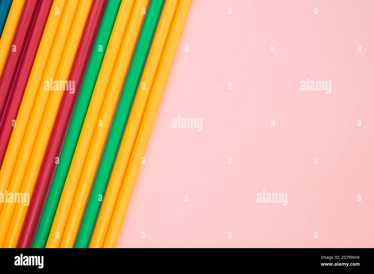 High angle shot of colorful crayons on a pink surface Stock Photo - Alamy