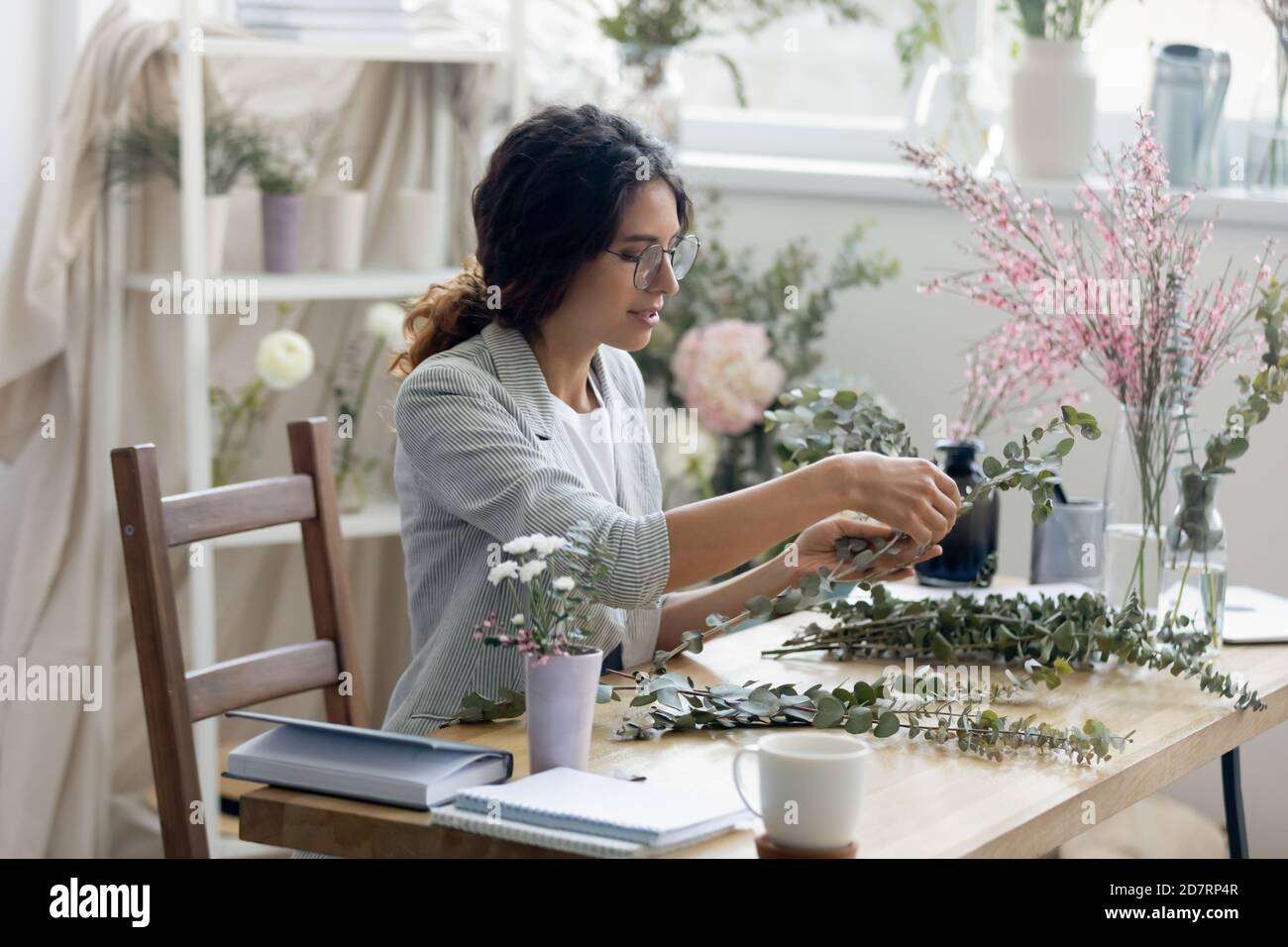 Creative woman florist arrange floral compositions at desk Stock Photo ...