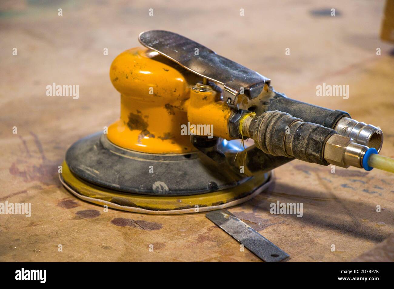 Yellow sander close-up on the table, dirty sander Stock Photo - Alamy