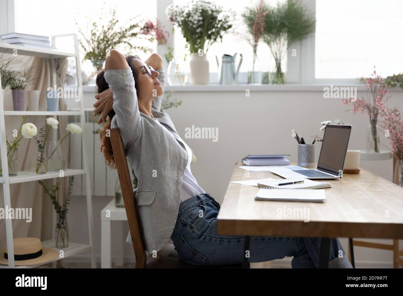 Calm female decorator relax in chair at workplace Stock Photo - Alamy