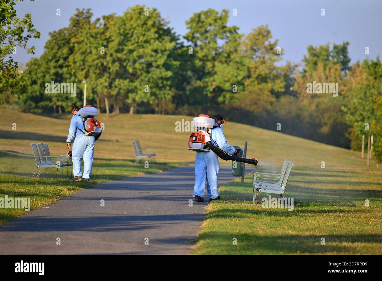 Disinfection of steel benches in the park against Covid-19. Industrial ...