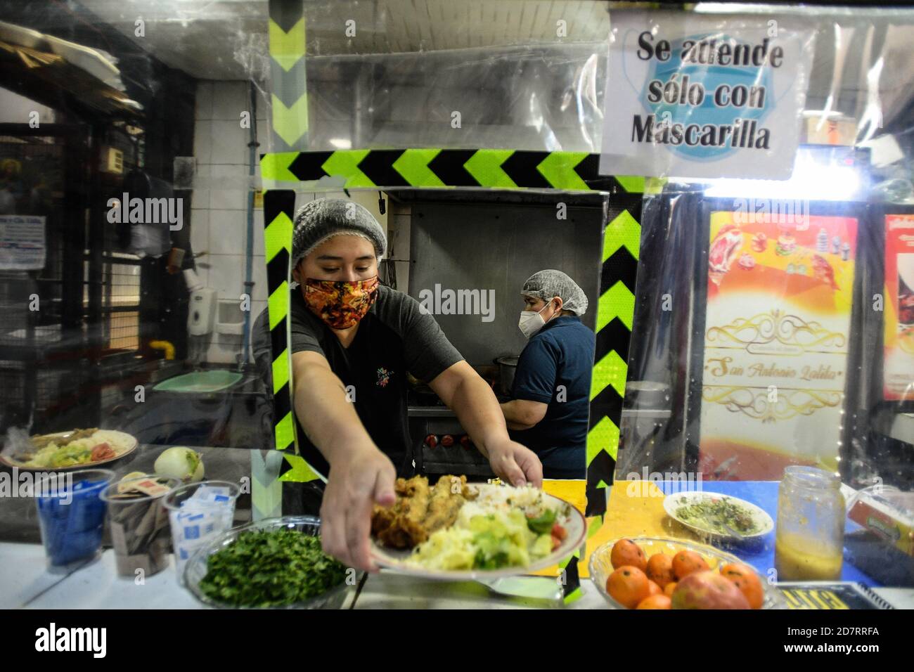 Santiago, Chile. 21st Oct, 2020. A chef wearing a face mask works at a ...