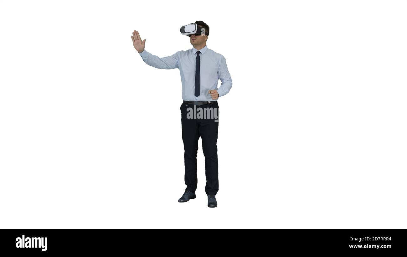 Businessman in VR glasses and interacting with virtual reality objects ...
