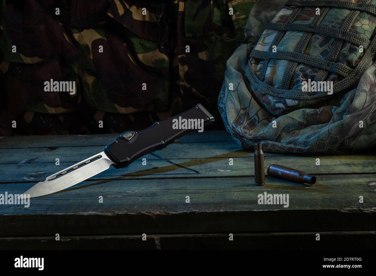 Sharp knife and cartridges. Army uniform, knives and casings Stock ...