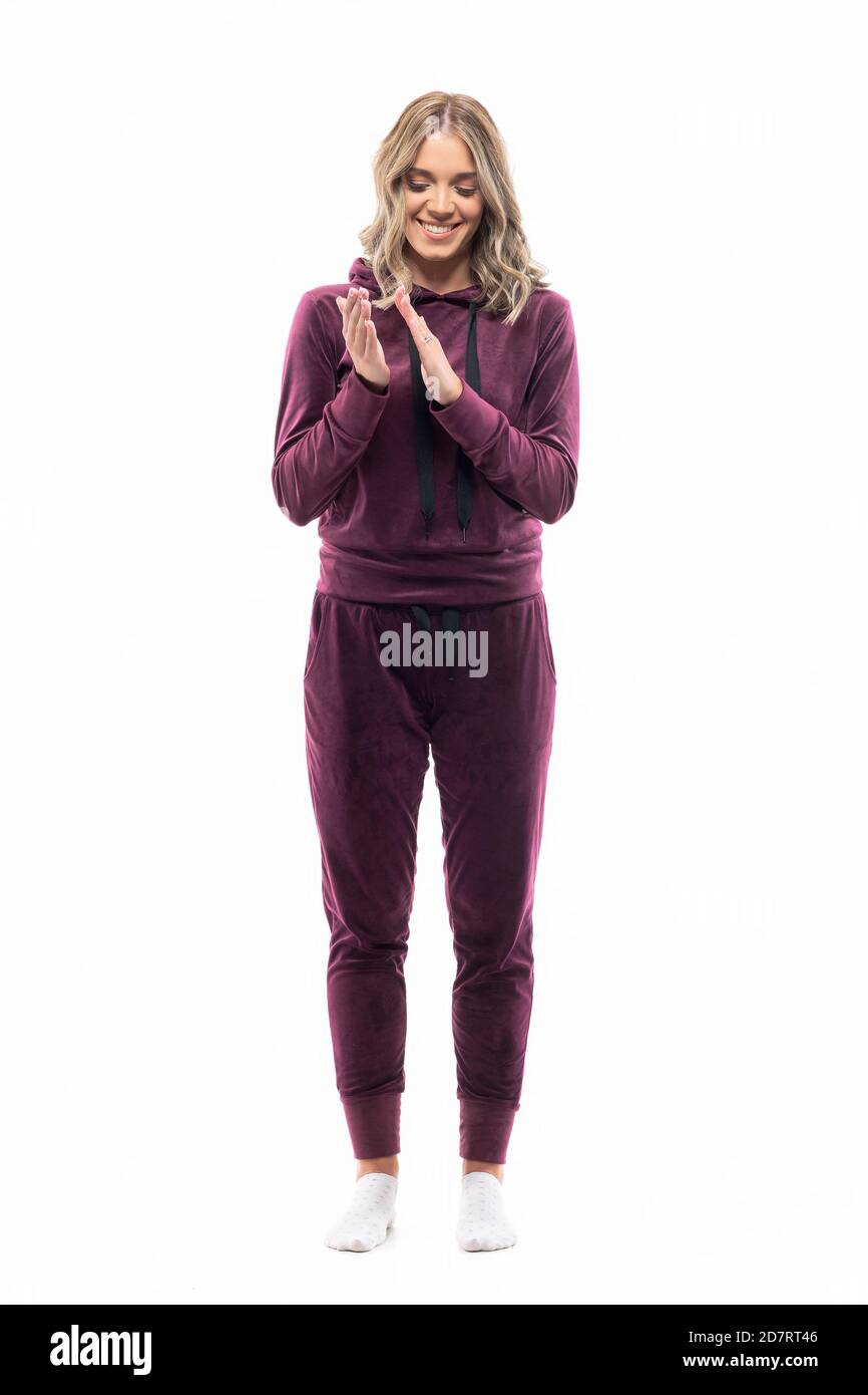 Shy young pretty supportive woman applauding smiling and looking down ...