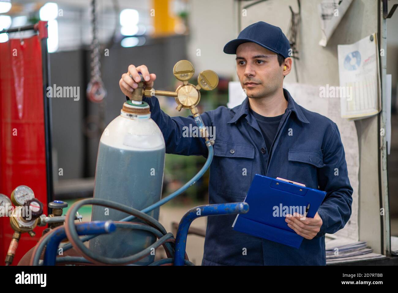Inspector checking a gas tank in an industrial factory Stock Photo - Alamy