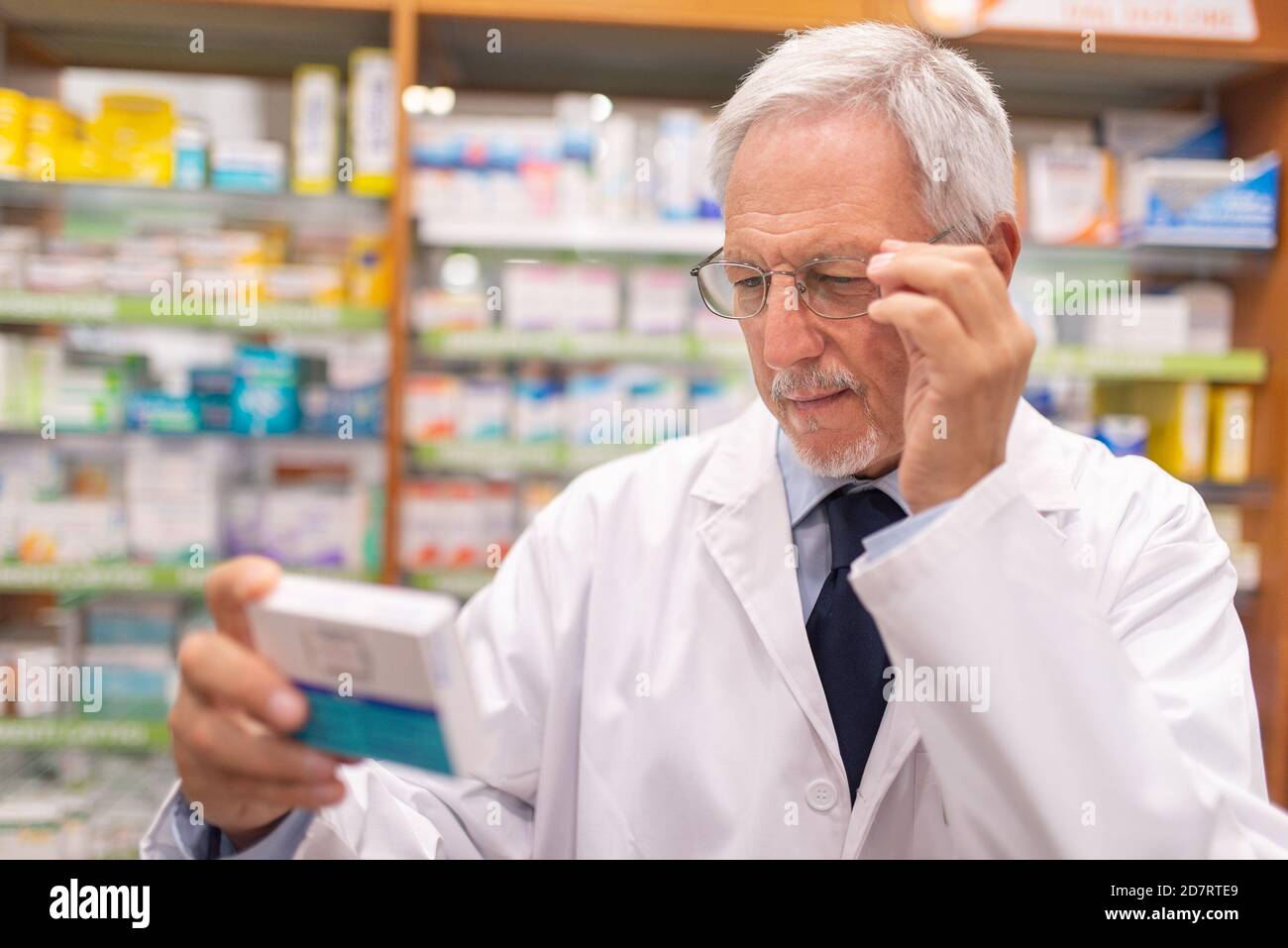 Chemist checking drugs shelf hi-res stock photography and images - Alamy