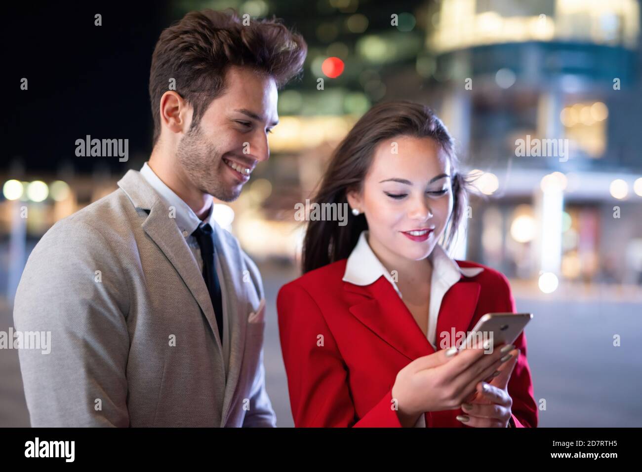 Business people businessman and businesswoman using a smartphone at ...