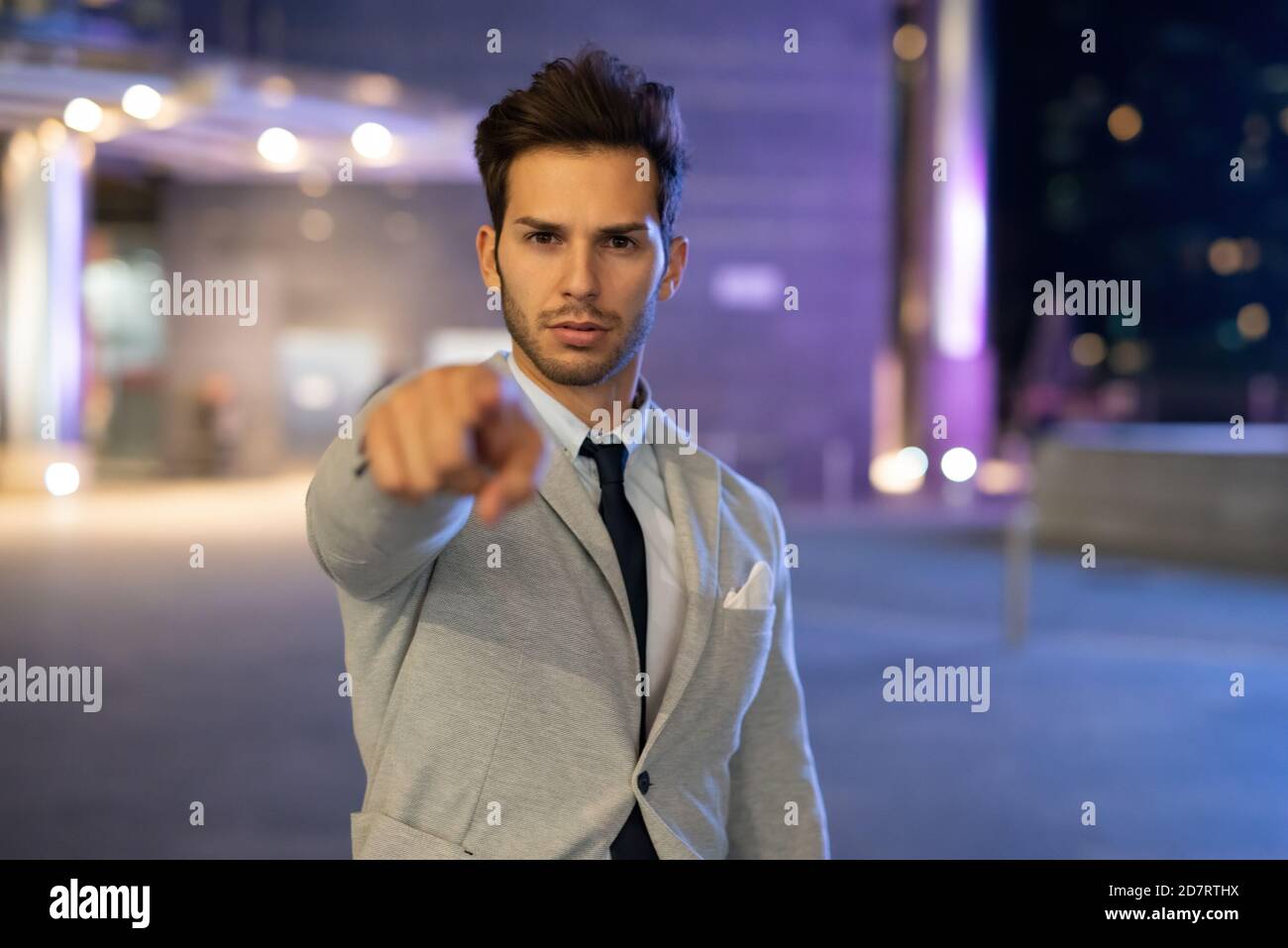 Man pointing his finger at you in a nocturnal city setting Stock Photo ...