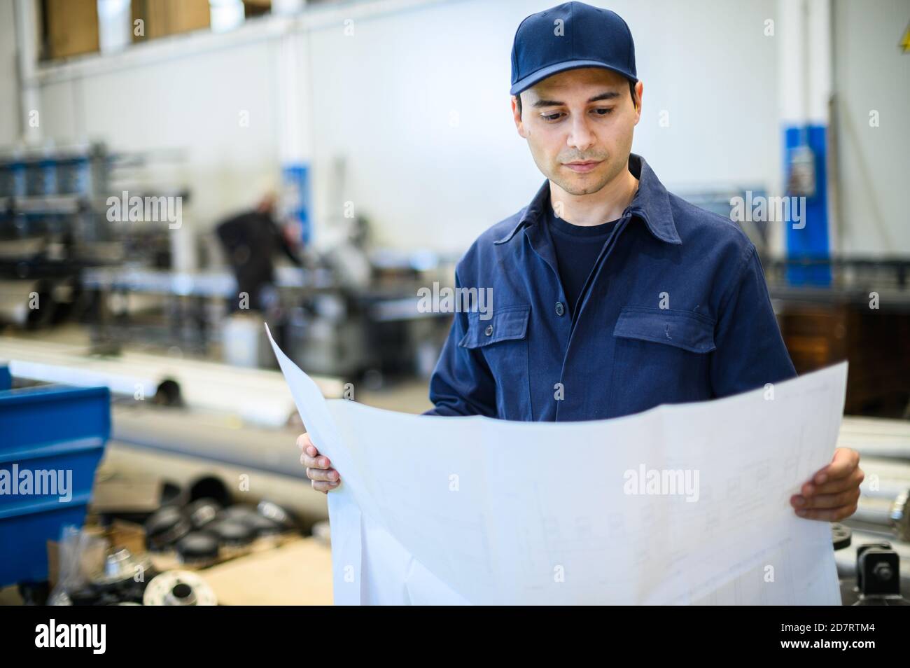 One engineers looking at a blueprint in a facility Stock Photo - Alamy