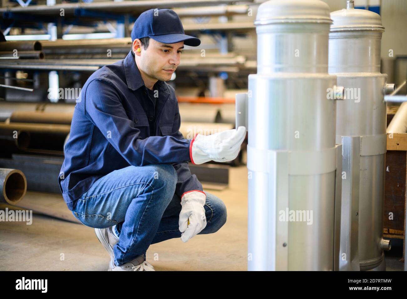 Worker in an industrial plant measuring the size of a pipe Stock Photo ...
