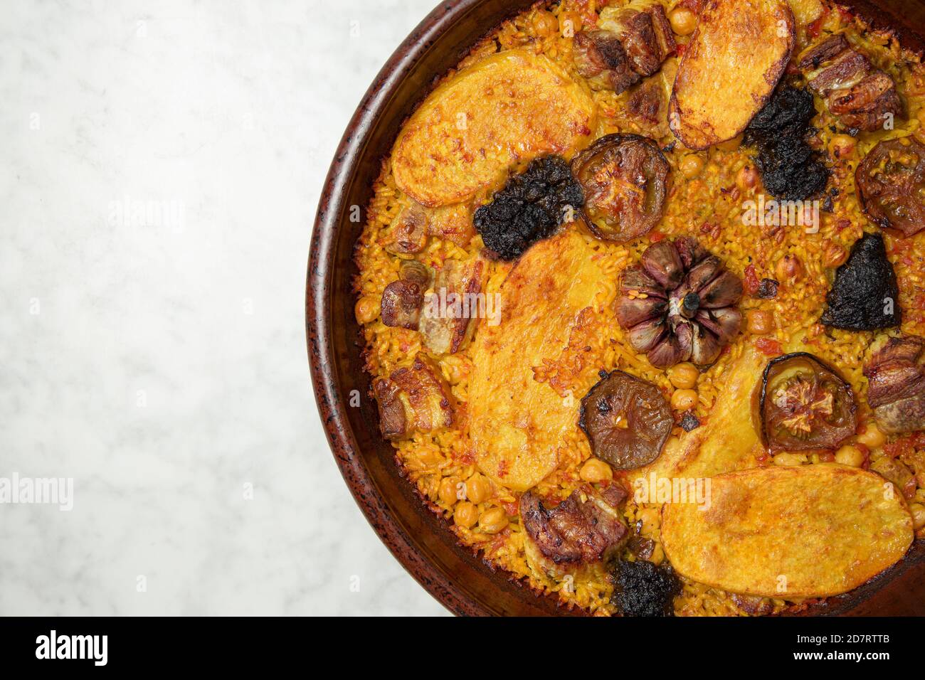 Delicious oven-baked rice on a marble table, top view. Valencia, Spain ...