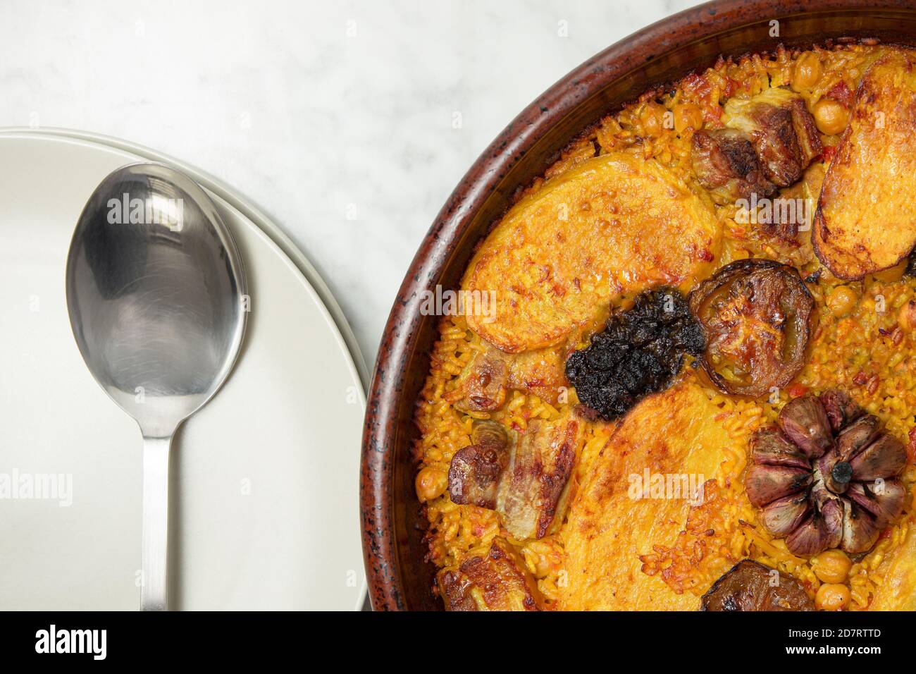 Delicious oven baked rice on a marble table, ready to serve. Valencia ...