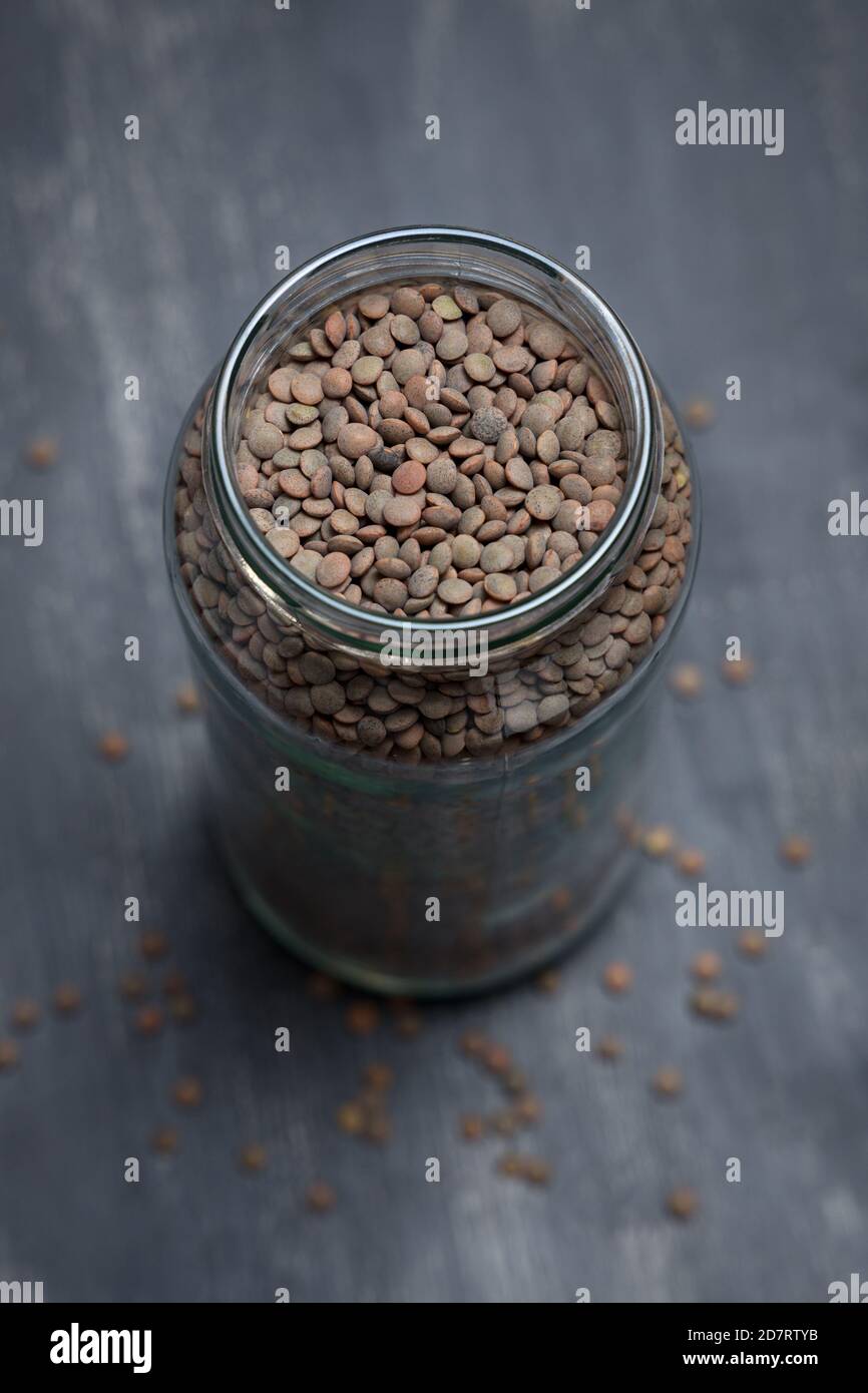 Glass jar full of lentils placed on a tabletop. Eco friendly concept ...