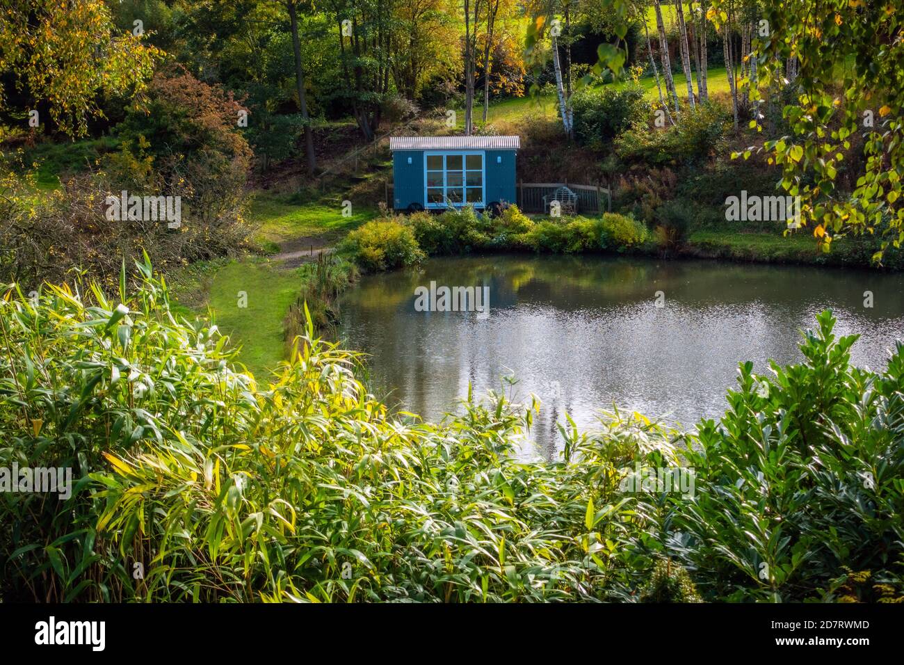 Pretty Shepherd's hut in private garden with a lake Stock Photo - Alamy
