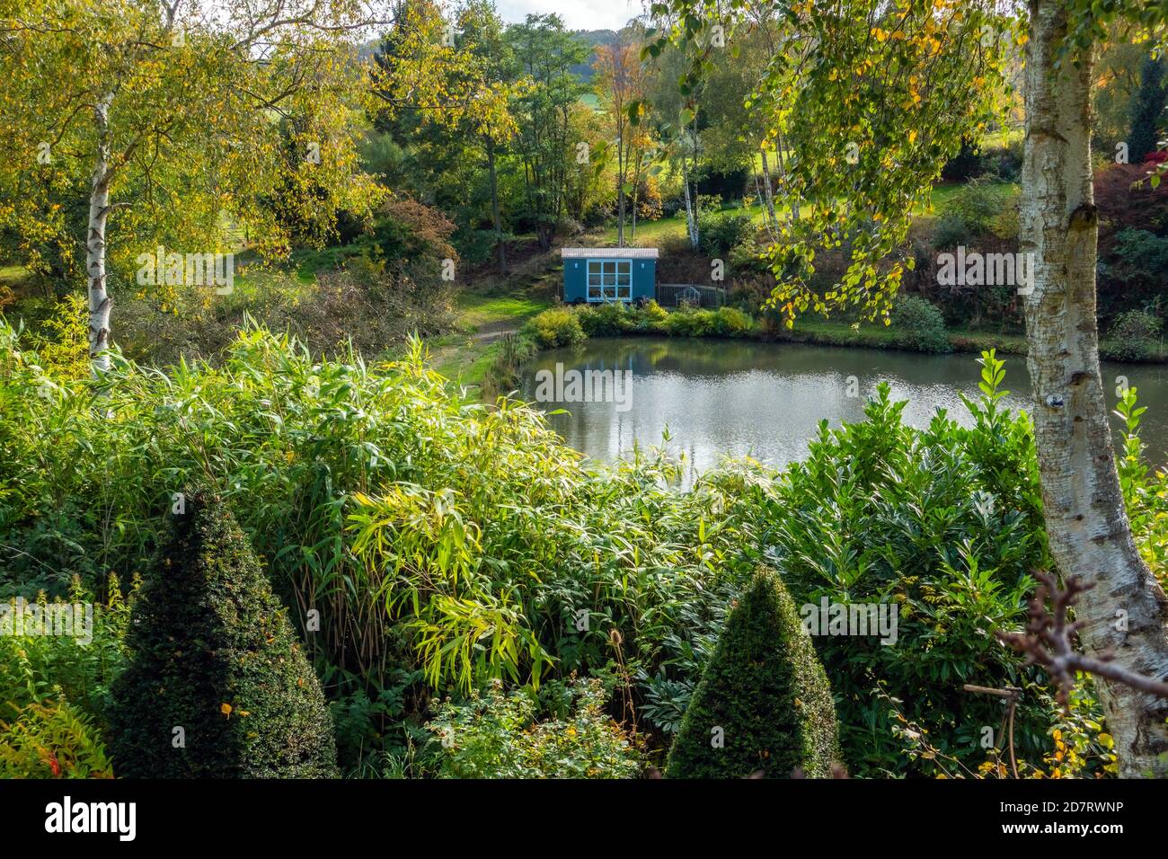 Pretty Shepherd's hut in private garden with a lake Stock Photo - Alamy