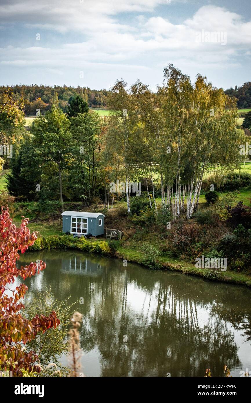 Pretty Shepherd's hut in private garden with a lake Stock Photo - Alamy