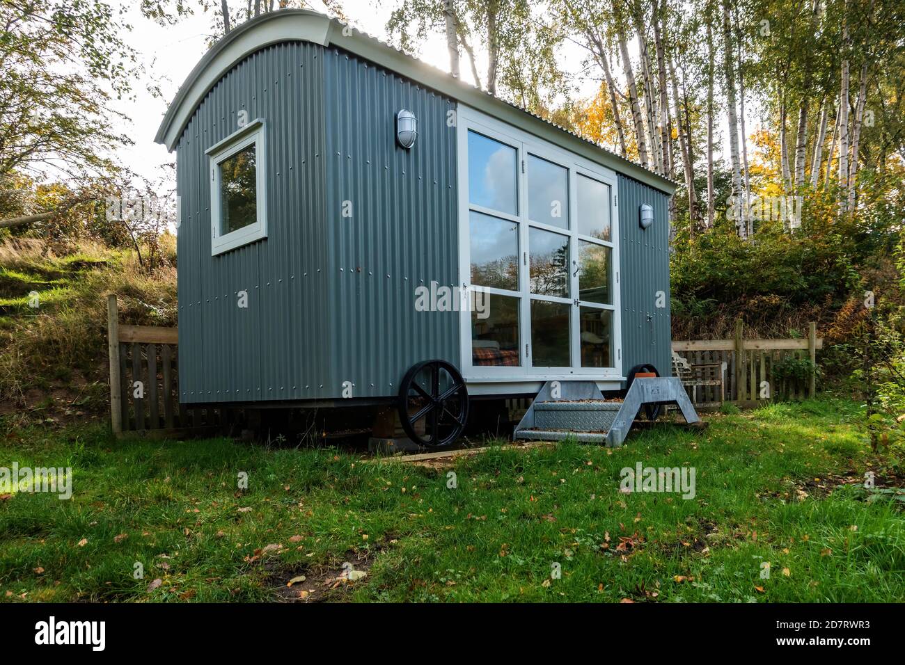 Pretty Shepherd's hut in private garden with a lake Stock Photo - Alamy