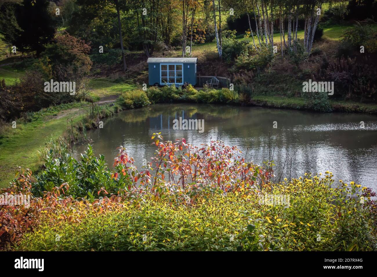 Pretty Shepherd's hut in private garden with a lake Stock Photo - Alamy