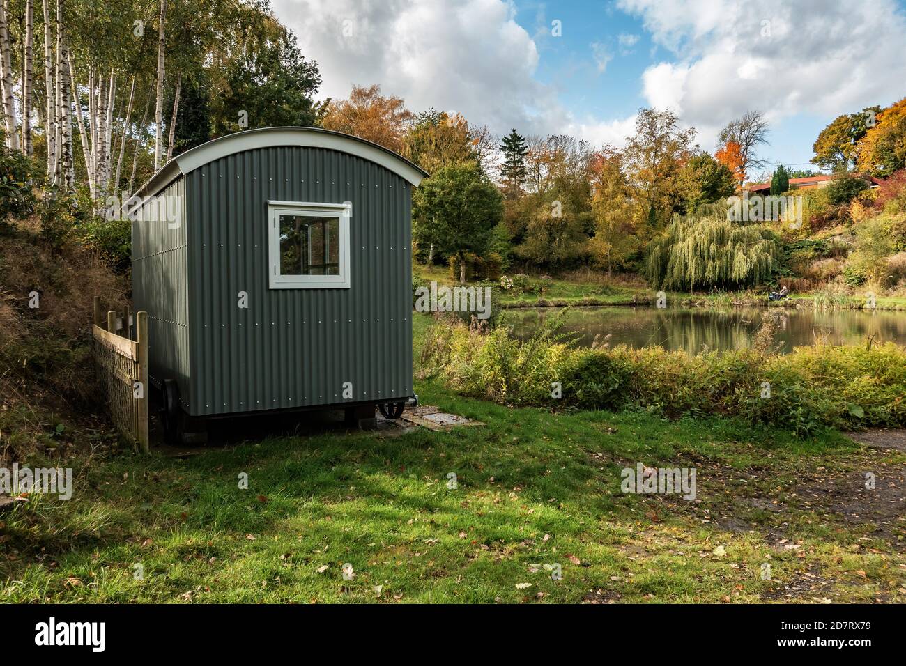 Pretty Shepherd's hut in private garden with a lake Stock Photo - Alamy