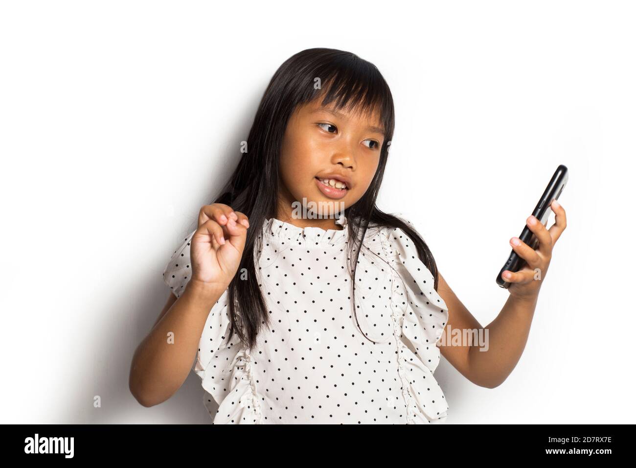 Happy asian little girl using smart phone on white background Stock ...