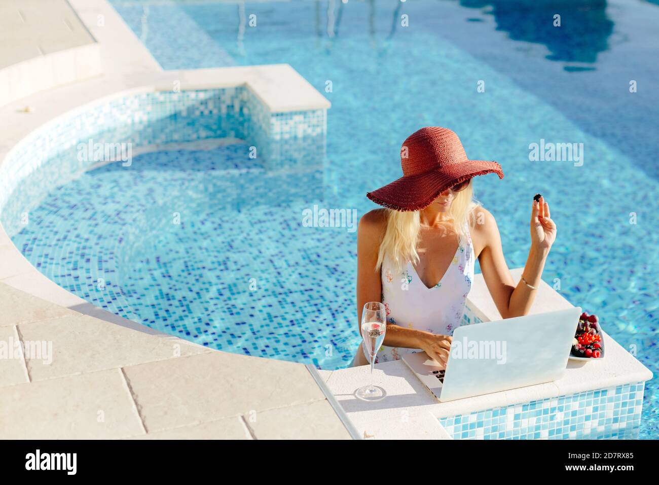 woman using laptop and work remotely near swimming pool Stock Photo - Alamy