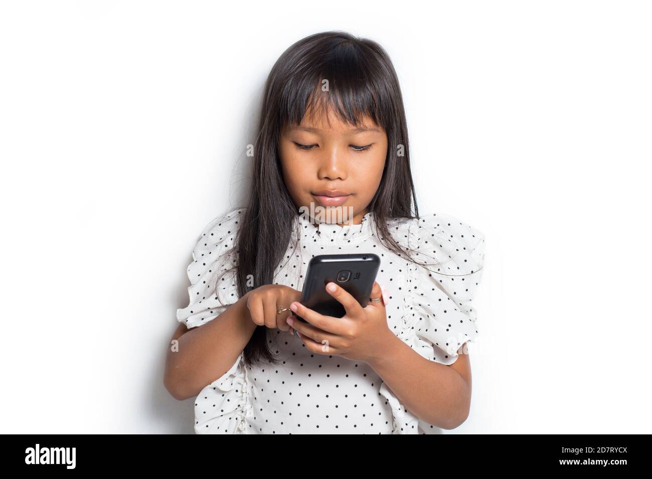 Happy asian little girl using smart phone on white background Stock ...