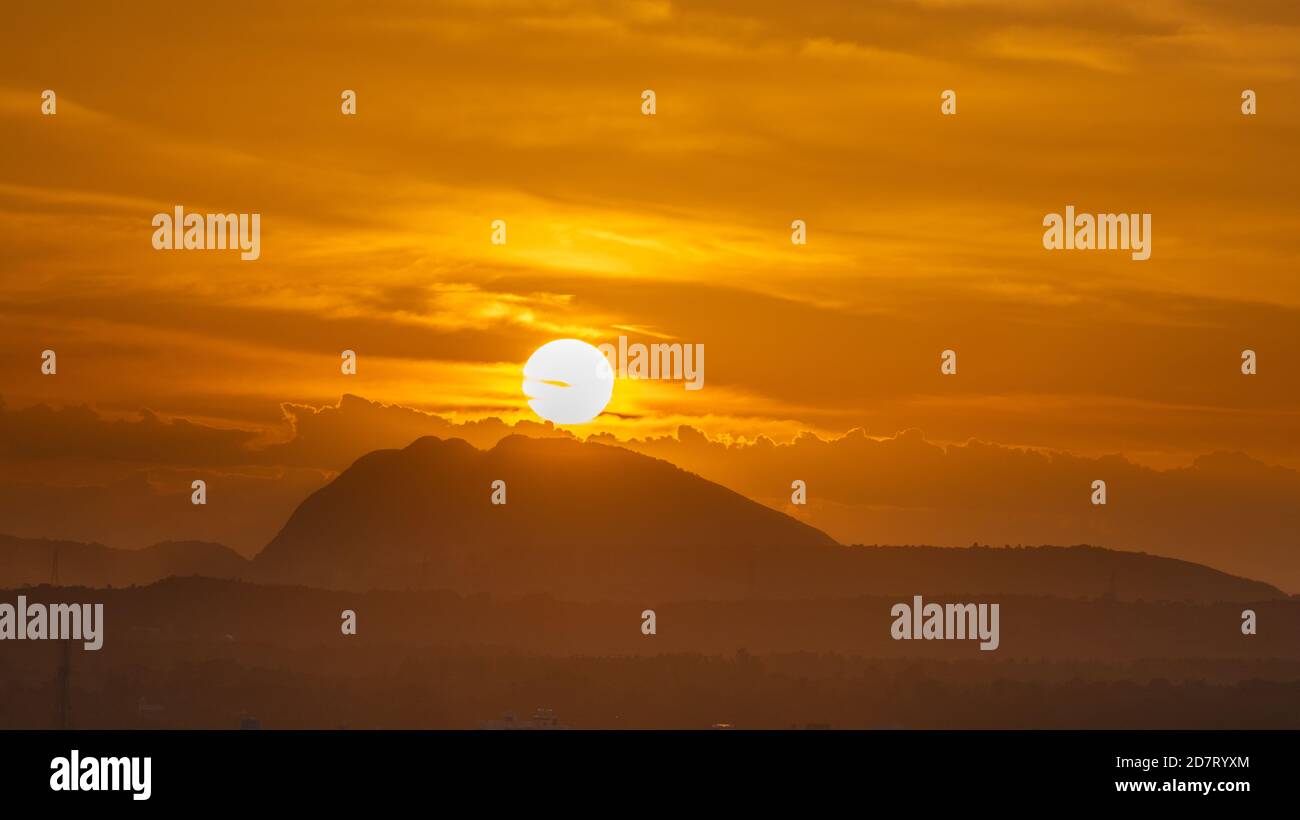Silhouette of a hill against beautiful golden hour light and beautiful ...