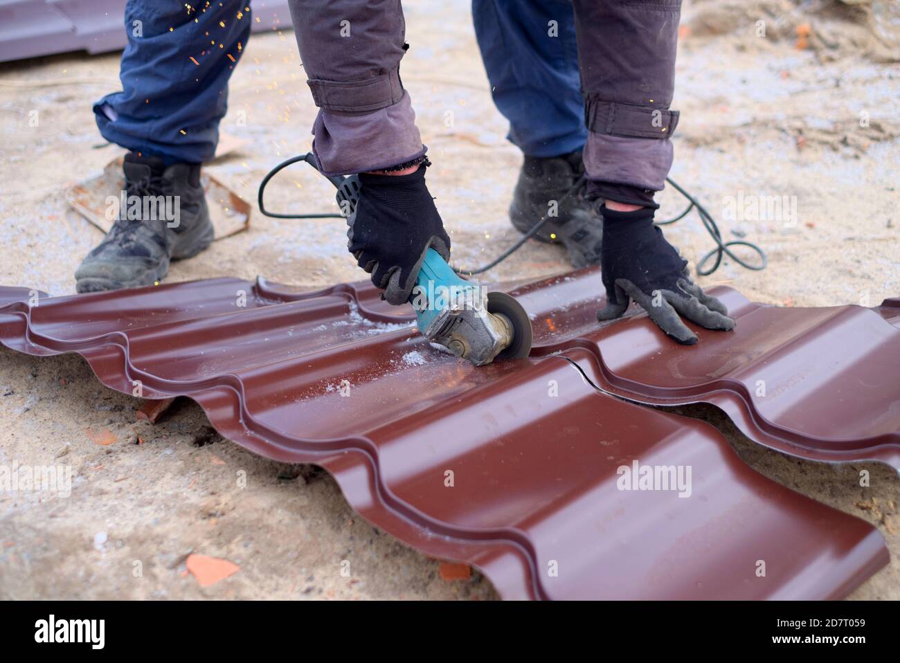 Worker use grinding machine for cutting of metal roofing sheet Stock ...