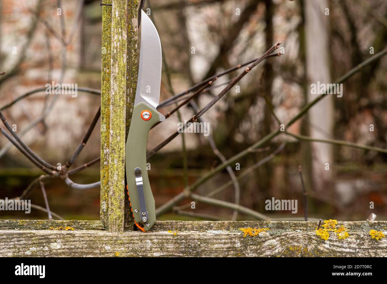 Knife with a wavy blade in a window frame. Photo of a knife in nature ...