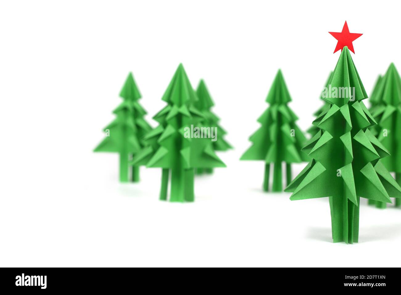 Origami Christmas trees of green craft paper isolated on white ...
