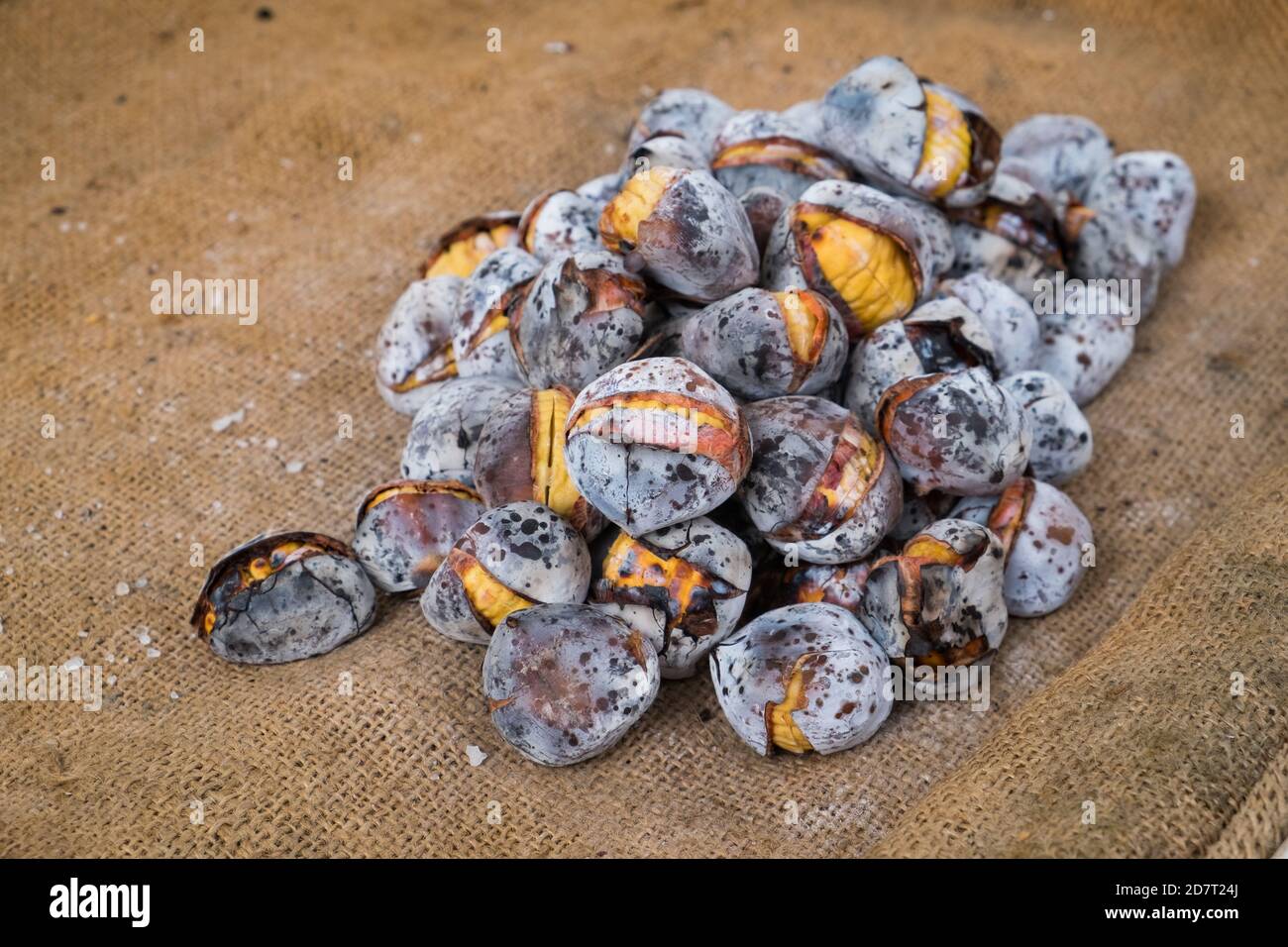 European delicacy roasted chestnuts sold at streets on a burlap ...
