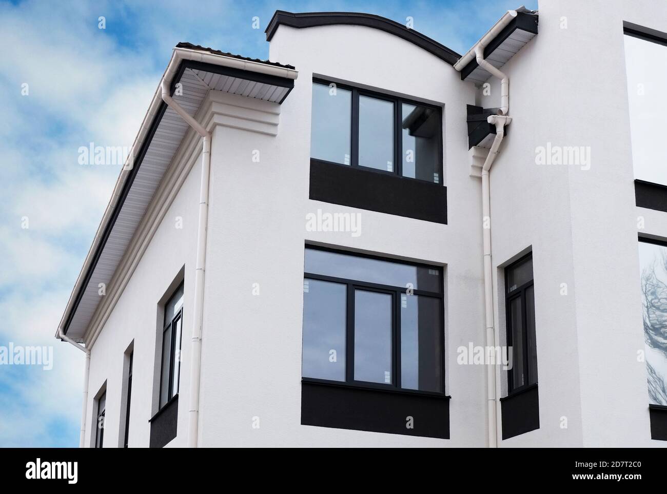 Newly installed construction frame house rain gutter system on the roof ...