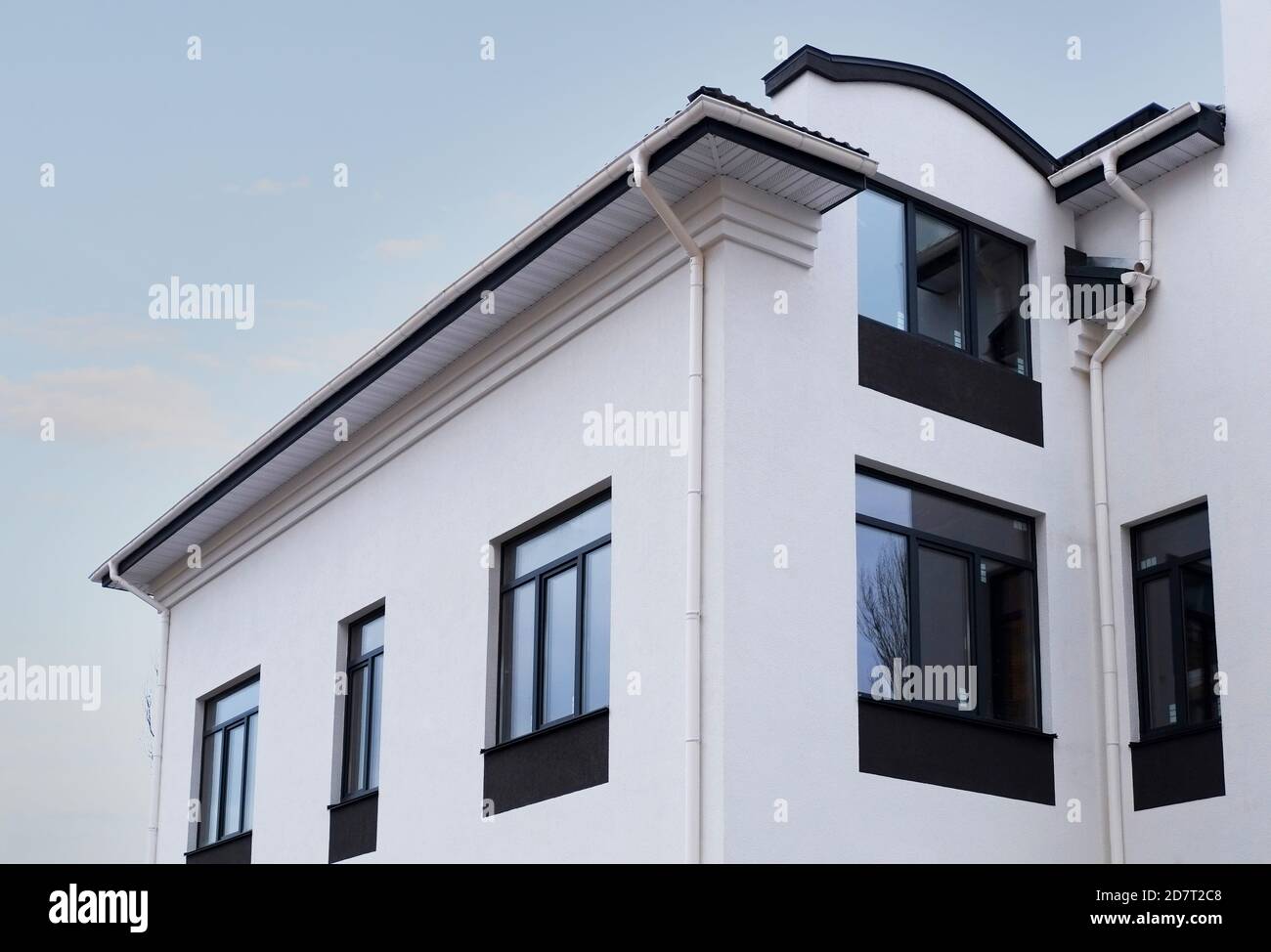 Newly installed construction frame house rain gutter system on the roof ...