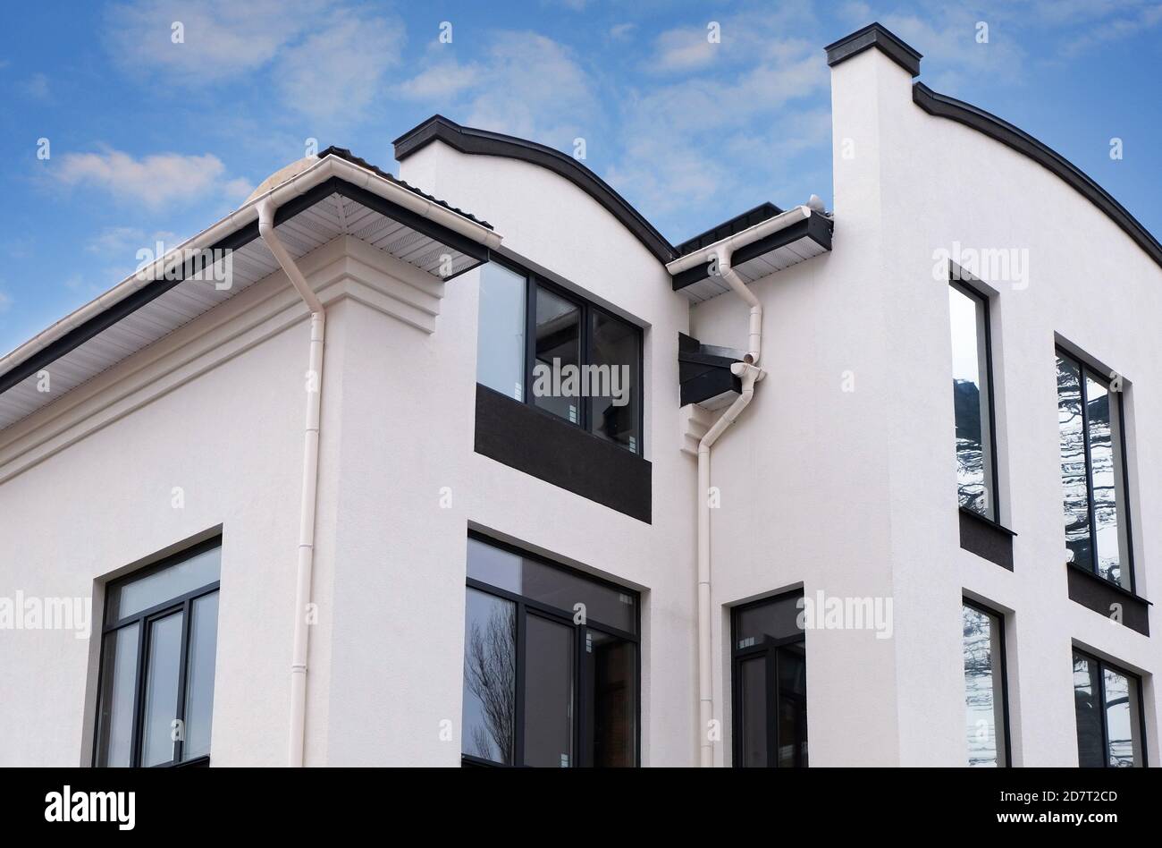 Construction of a new modern house.Newly installed rain gutter on house ...